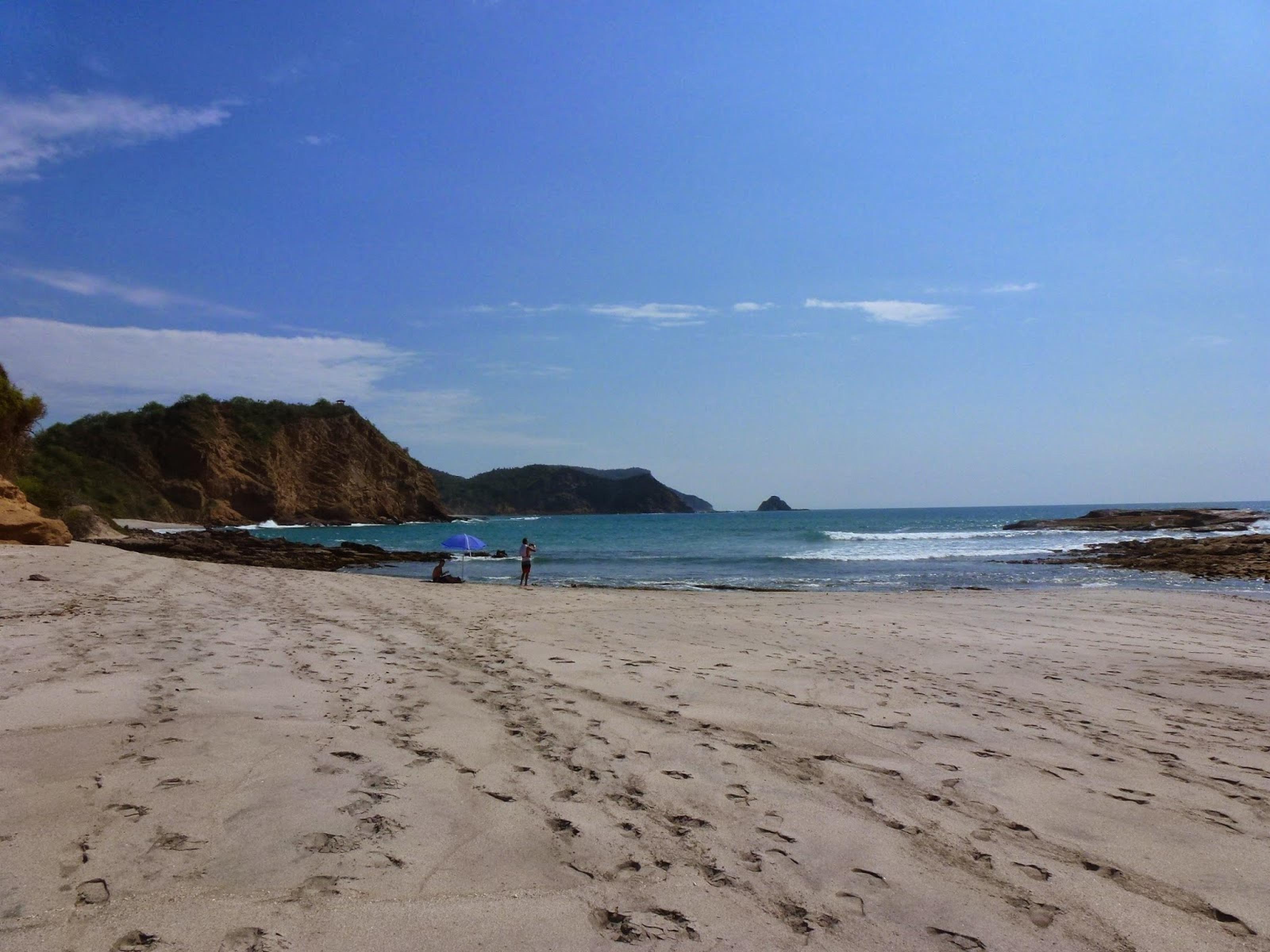Pacific Ocean Ecuador A Black Lava Rock Outcropping Extends Into The